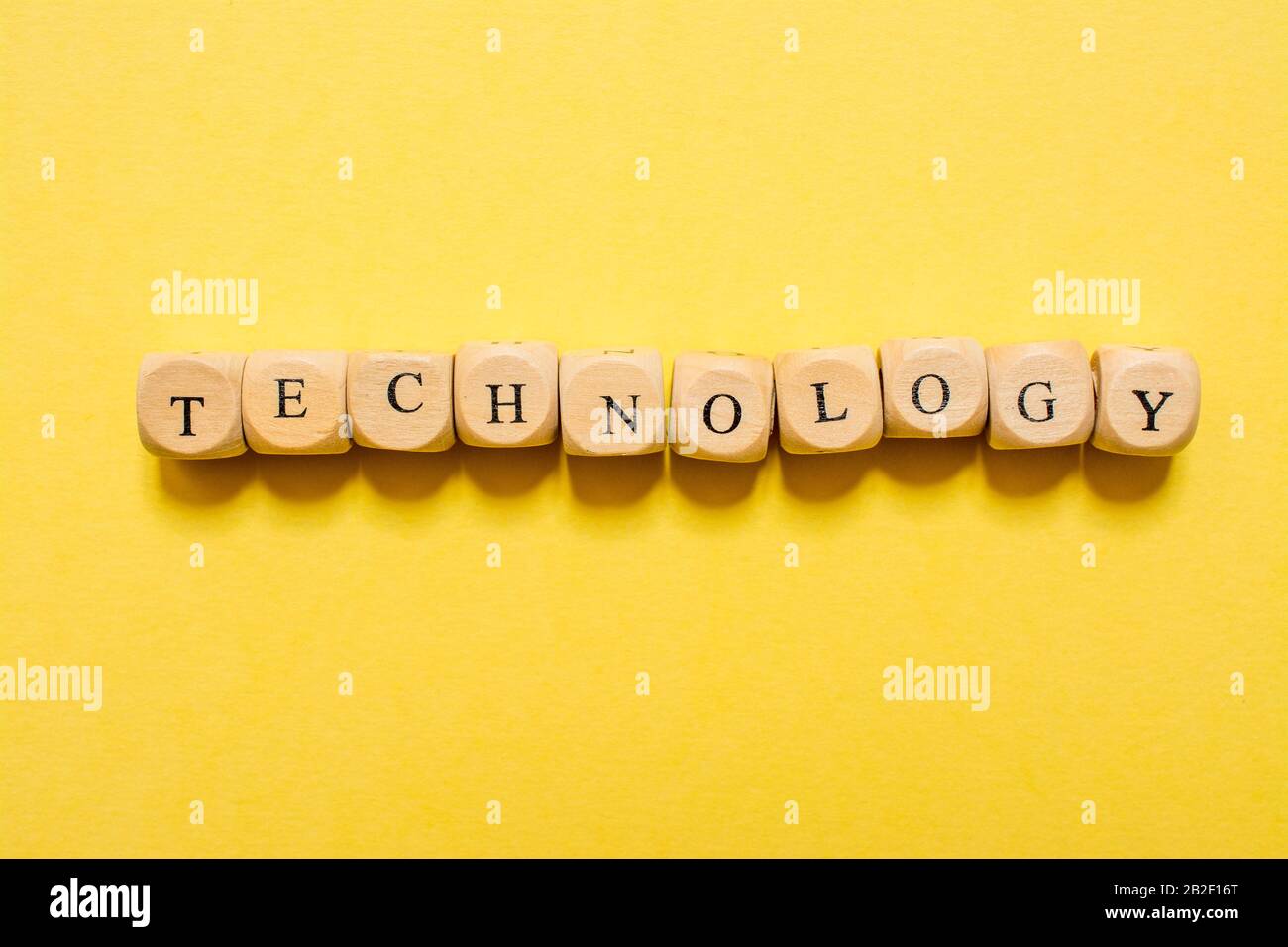 the word Technology, text made with dice on yellow background Stock ...