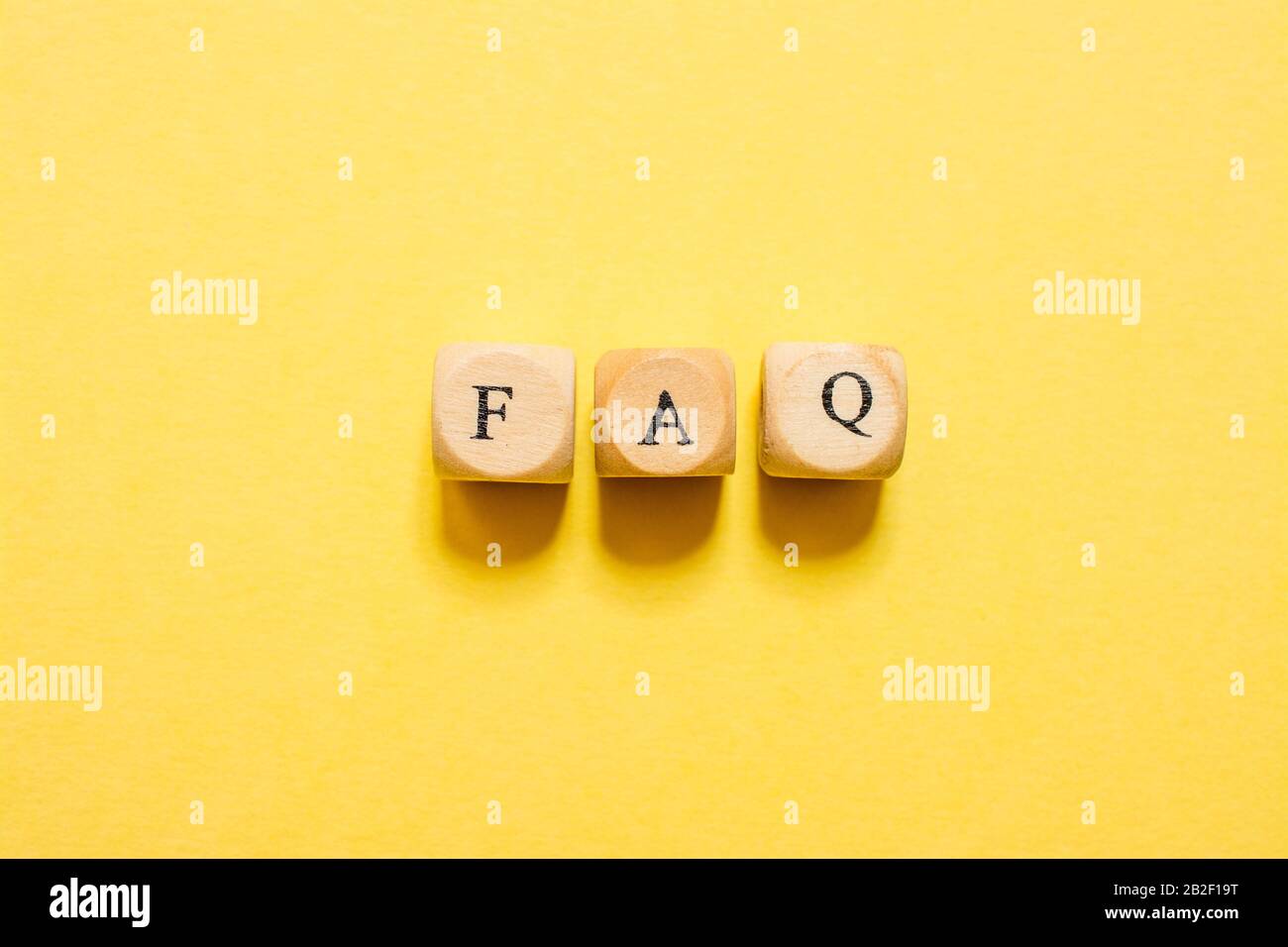the word FAQ, text made with dice on yellow background Stock Photo - Alamy