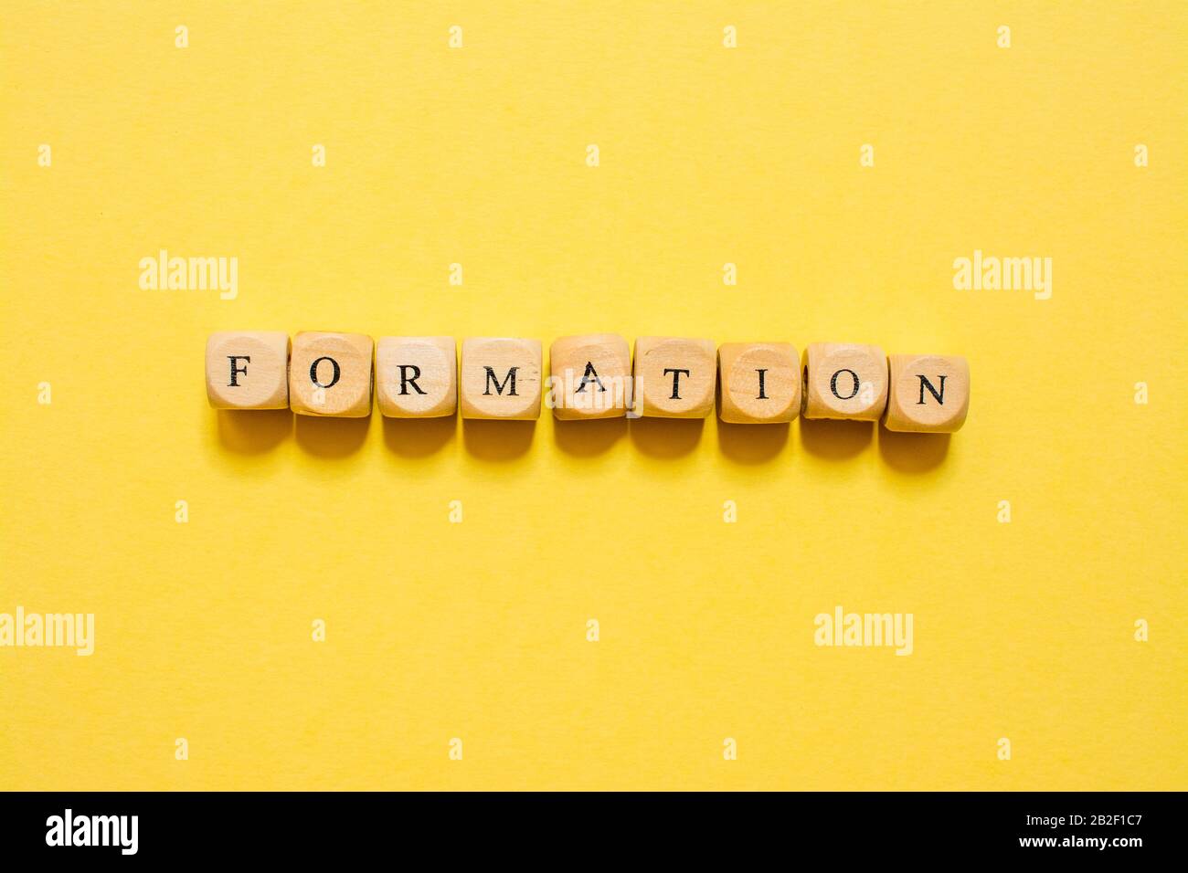 the word Formation, text made with dice on yellow background Stock ...