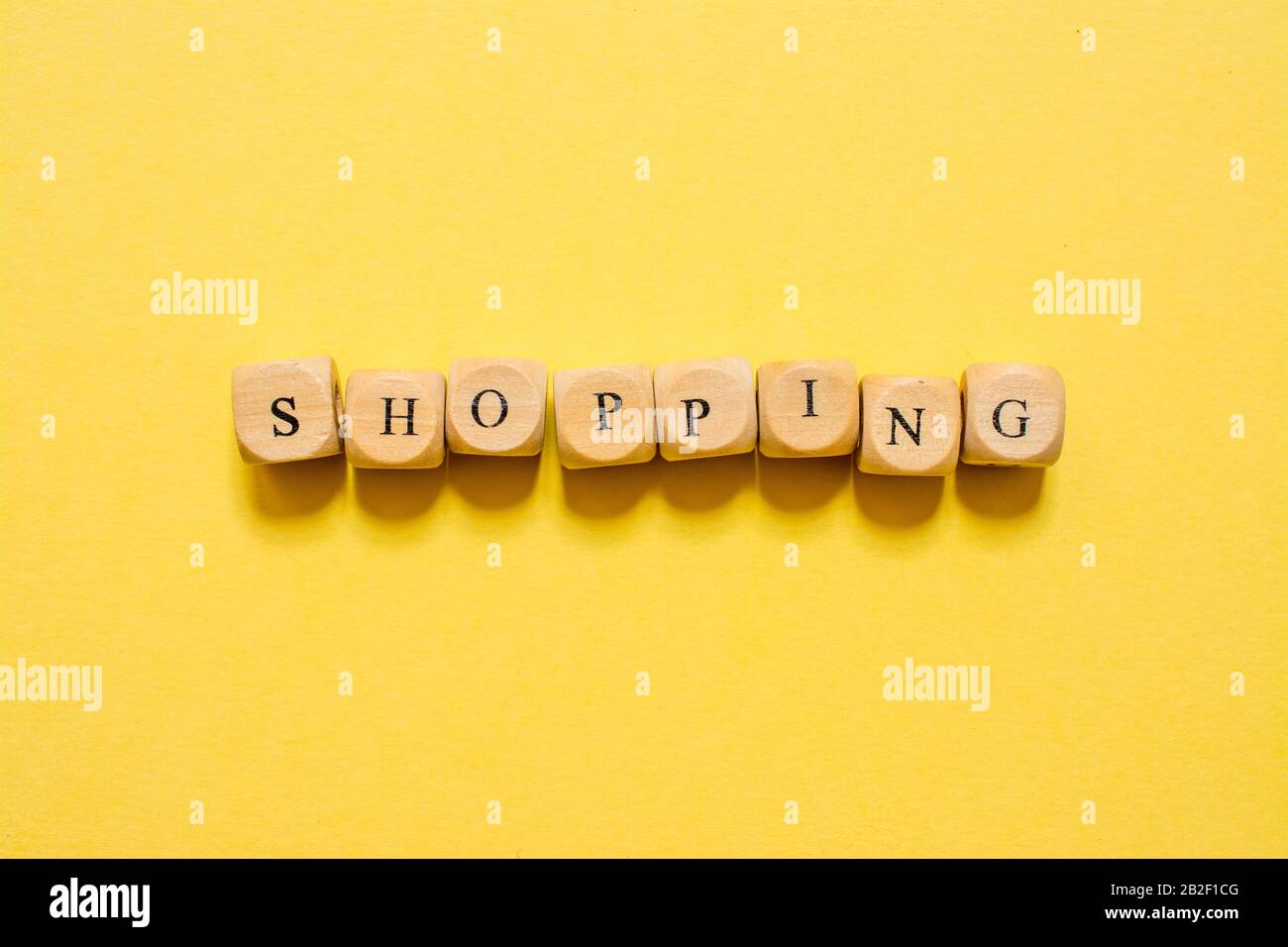 the word Shopping, text made with dice on yellow background Stock Photo ...