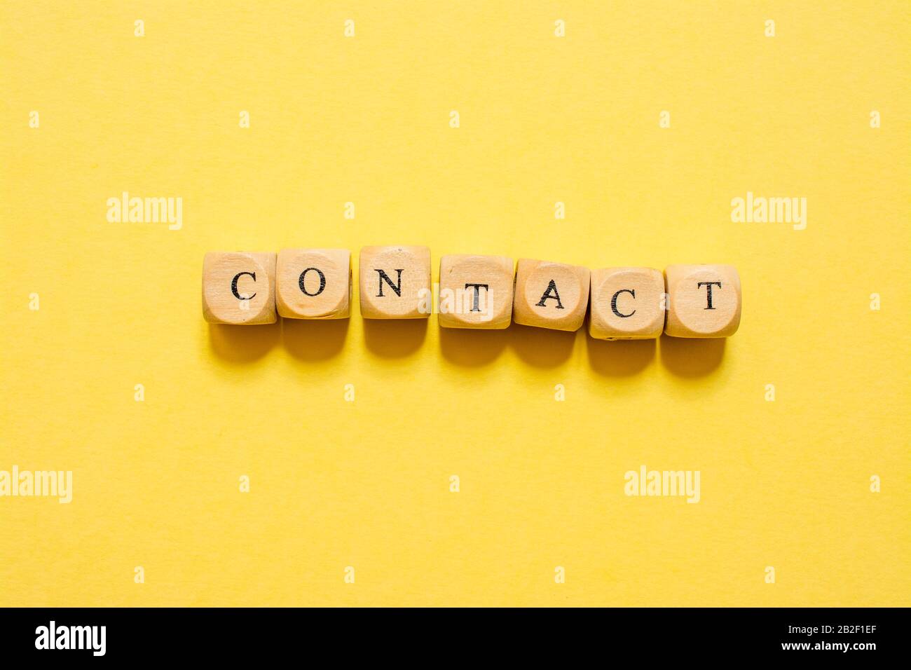 the word Contact, text made with dice on yellow background Stock Photo ...