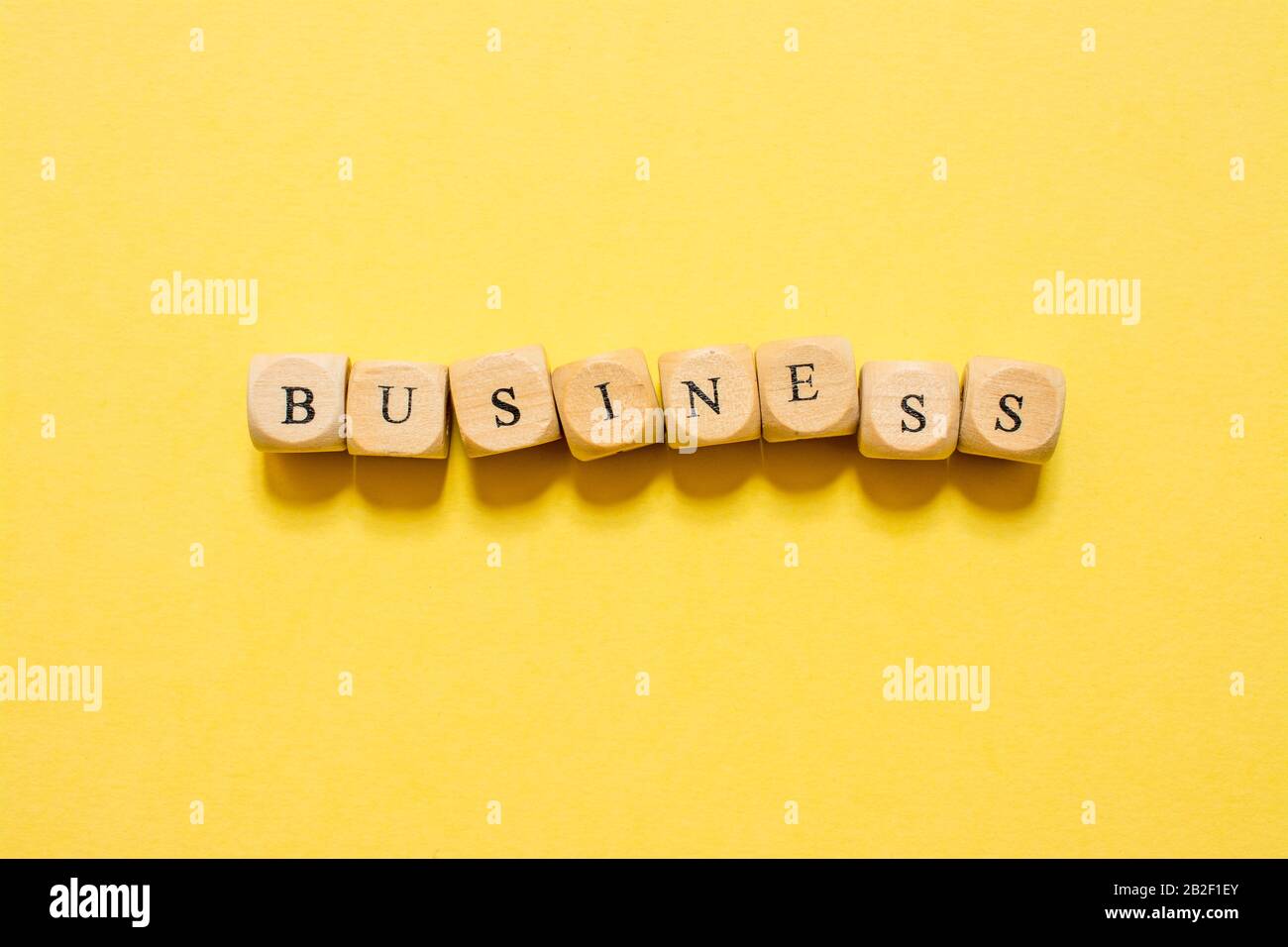the word Business, text made with dice on yellow background Stock Photo ...