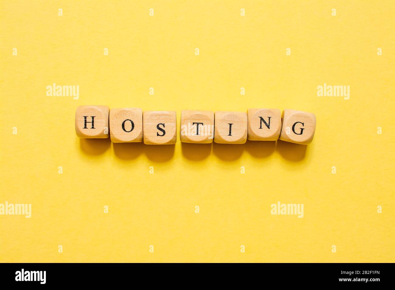 the word Hosting, text made with dice on yellow background Stock Photo ...