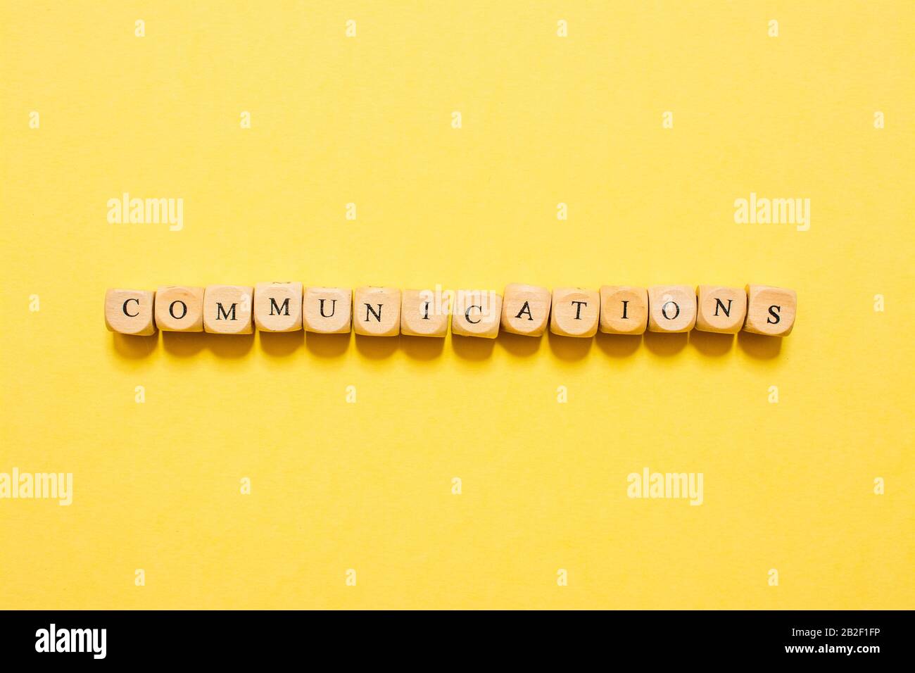 the word Communications, text made with dice on yellow background Stock ...