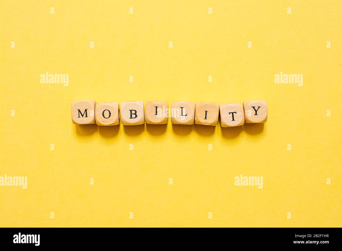 the word Mobility, text made with dice on yellow background Stock Photo ...