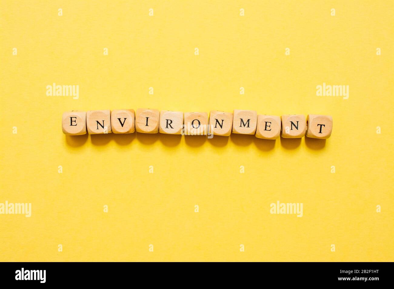 the word Environment, text made with dice on yellow background Stock ...