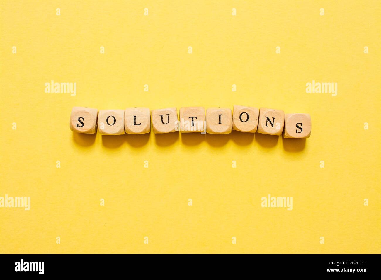 the word Solutions, text made with dice on yellow background Stock ...