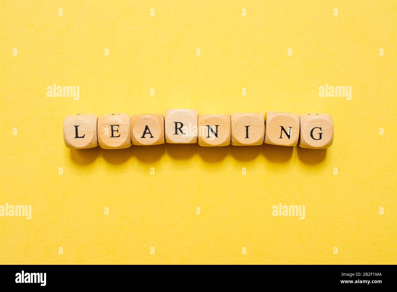 the word Learning, text made with dice on yellow background Stock Photo ...