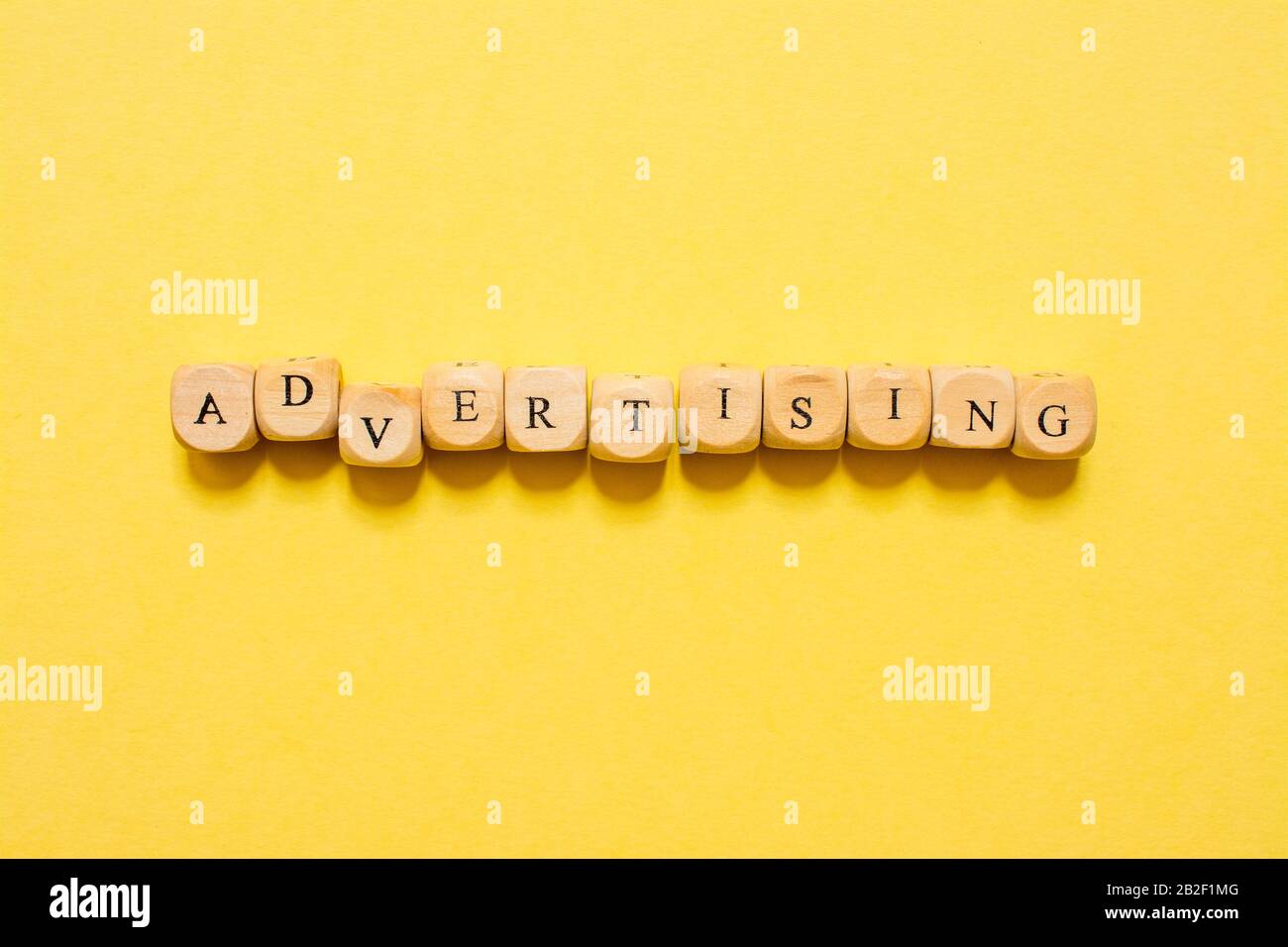 the word Advertising, text made with dice on yellow background Stock ...