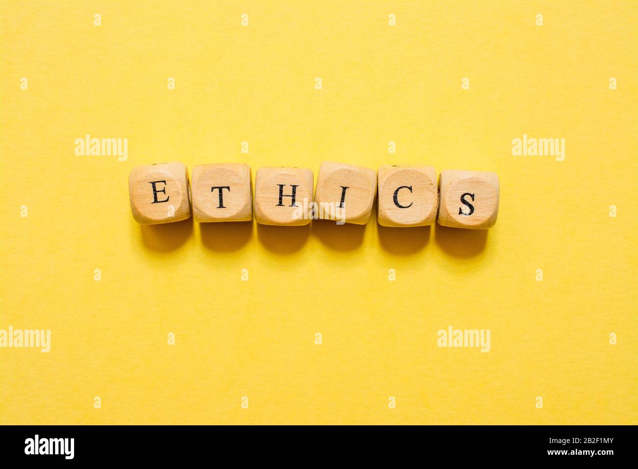 the word Ethics, text made with dice on yellow background Stock Photo ...