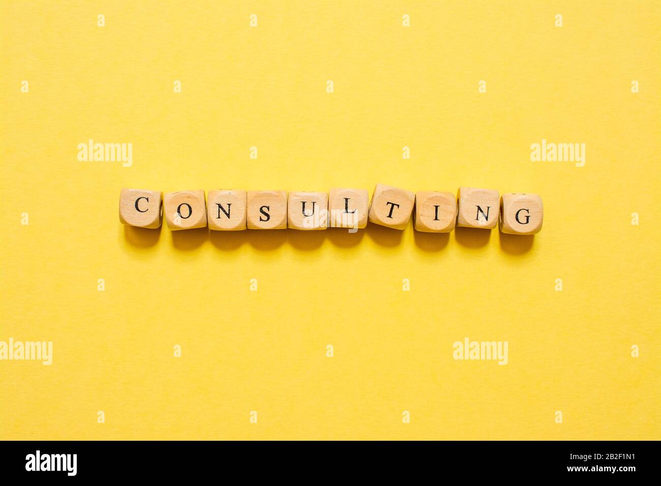 the word Consulting, text made with dice on yellow background Stock ...