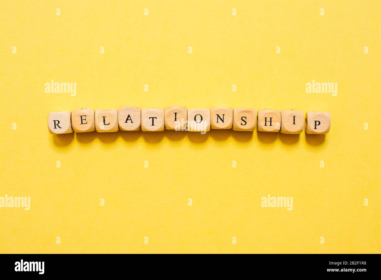 the word Relationship, text made with dice on yellow background Stock ...