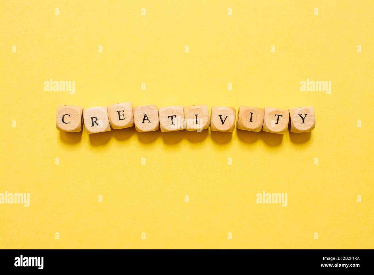 the word Creativity, text made with dice on yellow background Stock ...