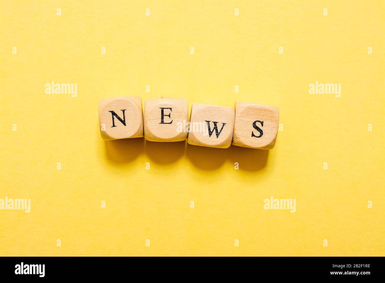 the word News, text made with dice on yellow background Stock Photo - Alamy