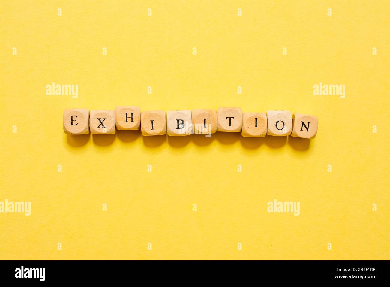 the word Exhibition, text made with dice on yellow background Stock ...
