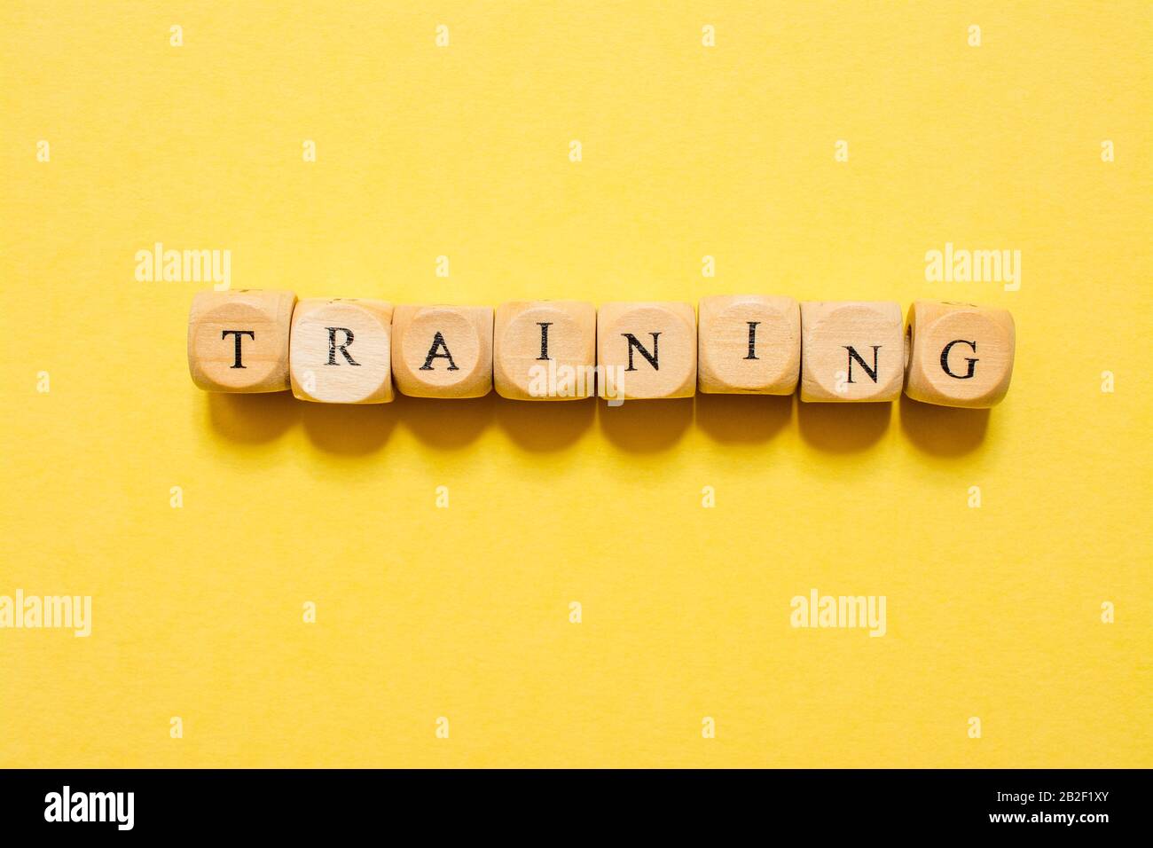 the word Training, text made with dice on yellow background Stock Photo ...