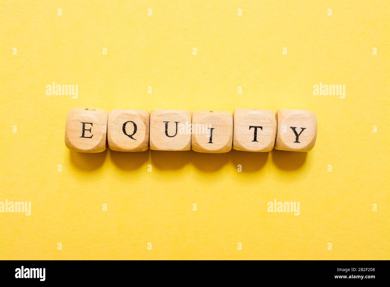 the word Equity, text made with dice on yellow background Stock Photo ...
