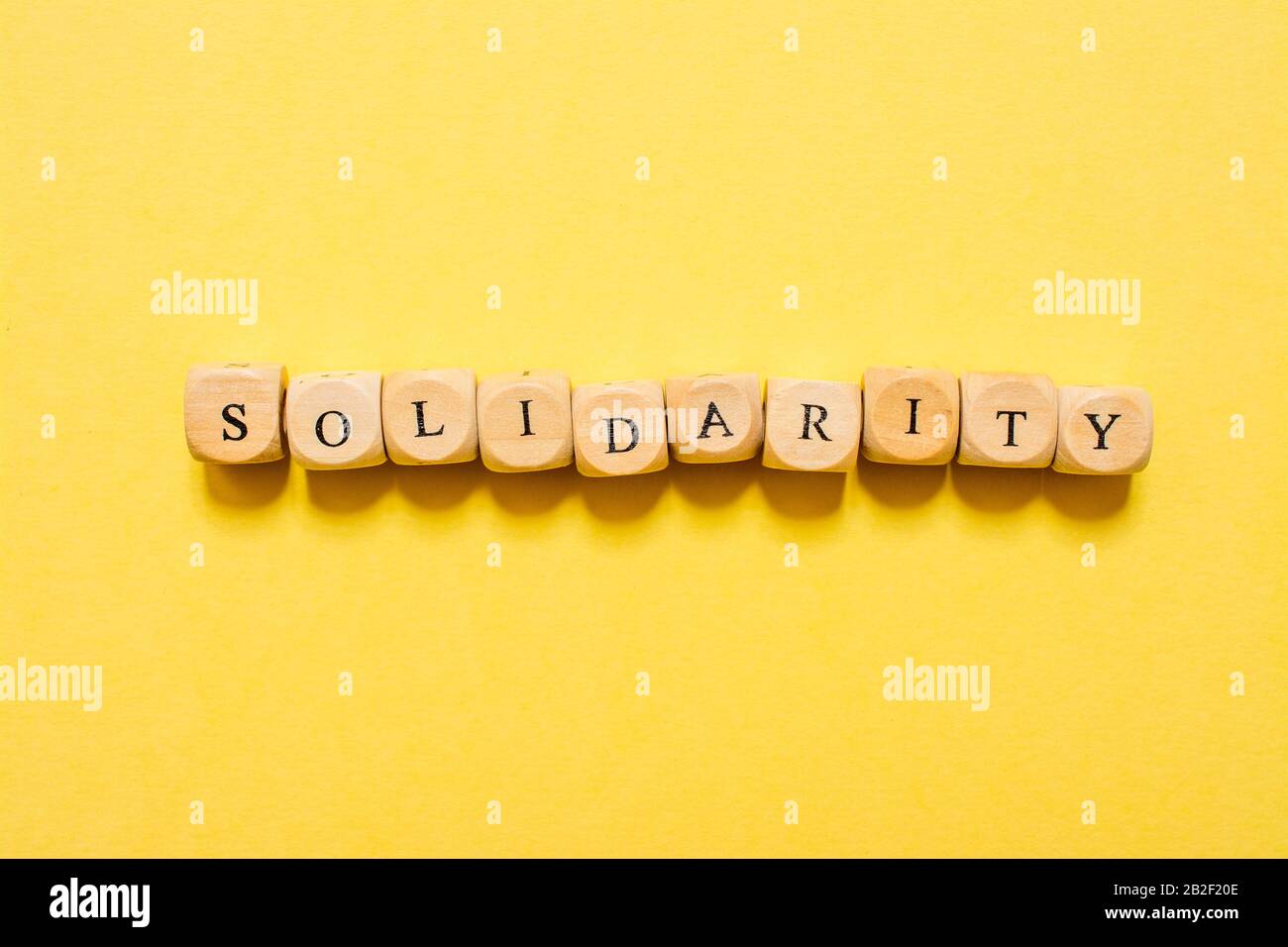 the word Solidarity, text made with dice on yellow background Stock ...