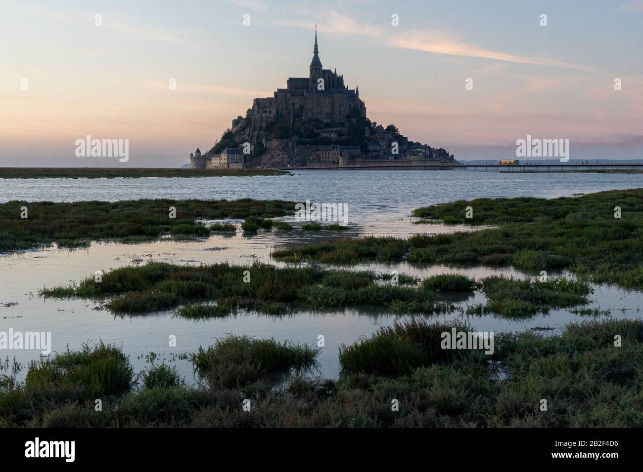 Sunset as the tide comes in at Mont Saint Michel, Normandy, France ...
