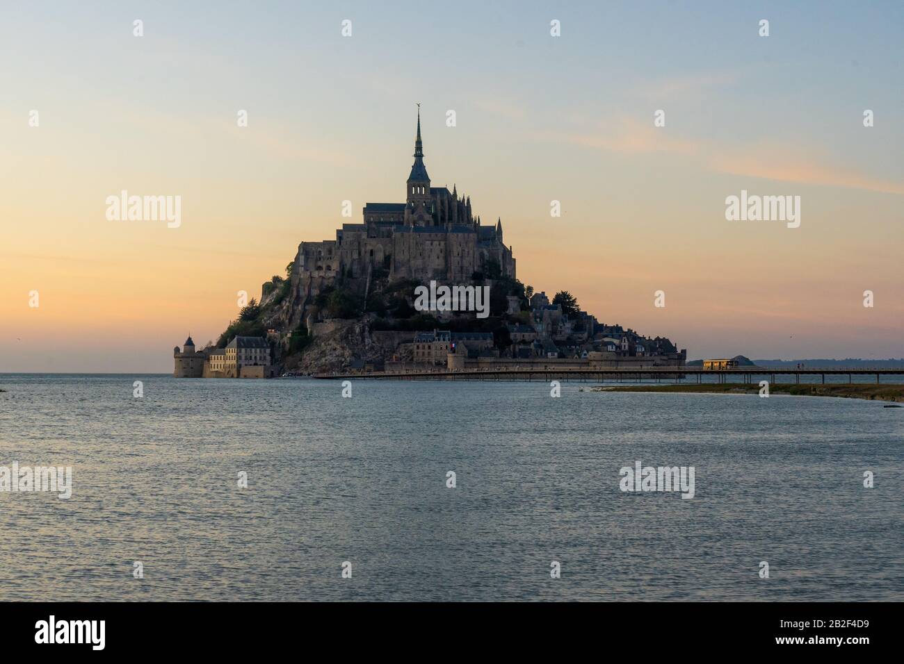 Sunset as the tide comes in at Mont Saint Michel, Normandy, France ...