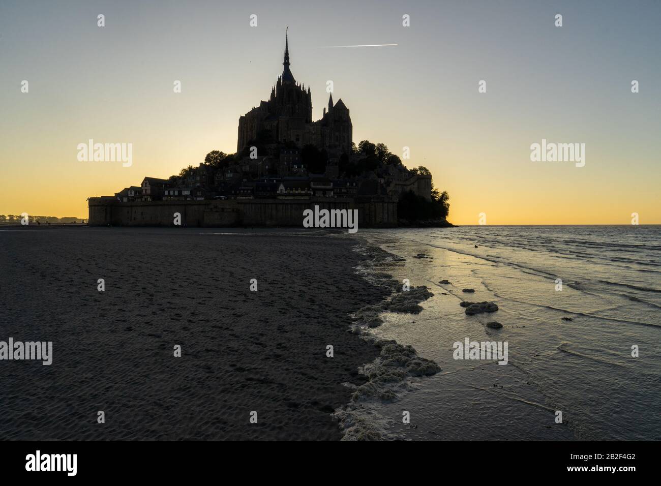 Sunset as the tide comes in at Mont Saint Michel, Normandy, France Stock Photo - Alamy