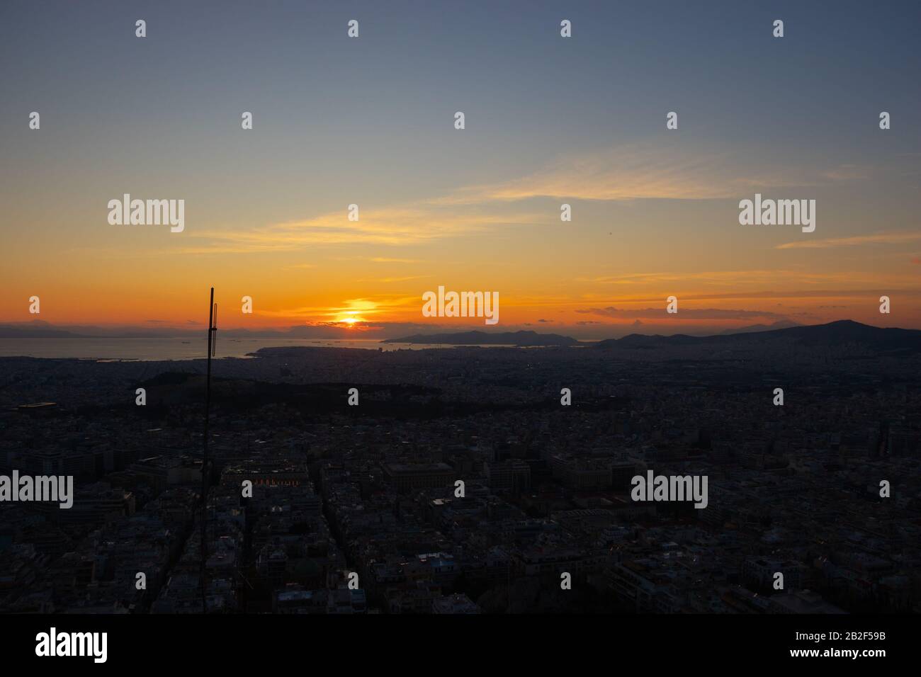 Sunset in Athens on a cloudy sky with a city view from Lycabettus hill ...