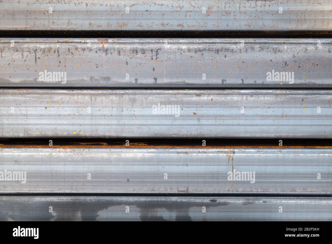 Stack of rolled metal products, side background texture. Steel pipes of ...