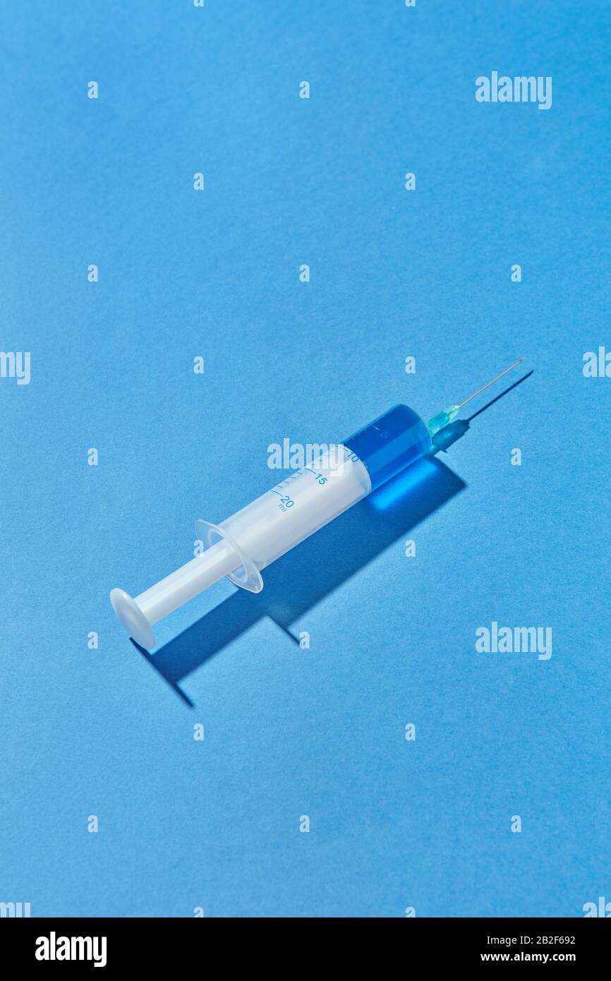 Blue serum or vaccine in plastic syringe 20 ml for an intravenous ...