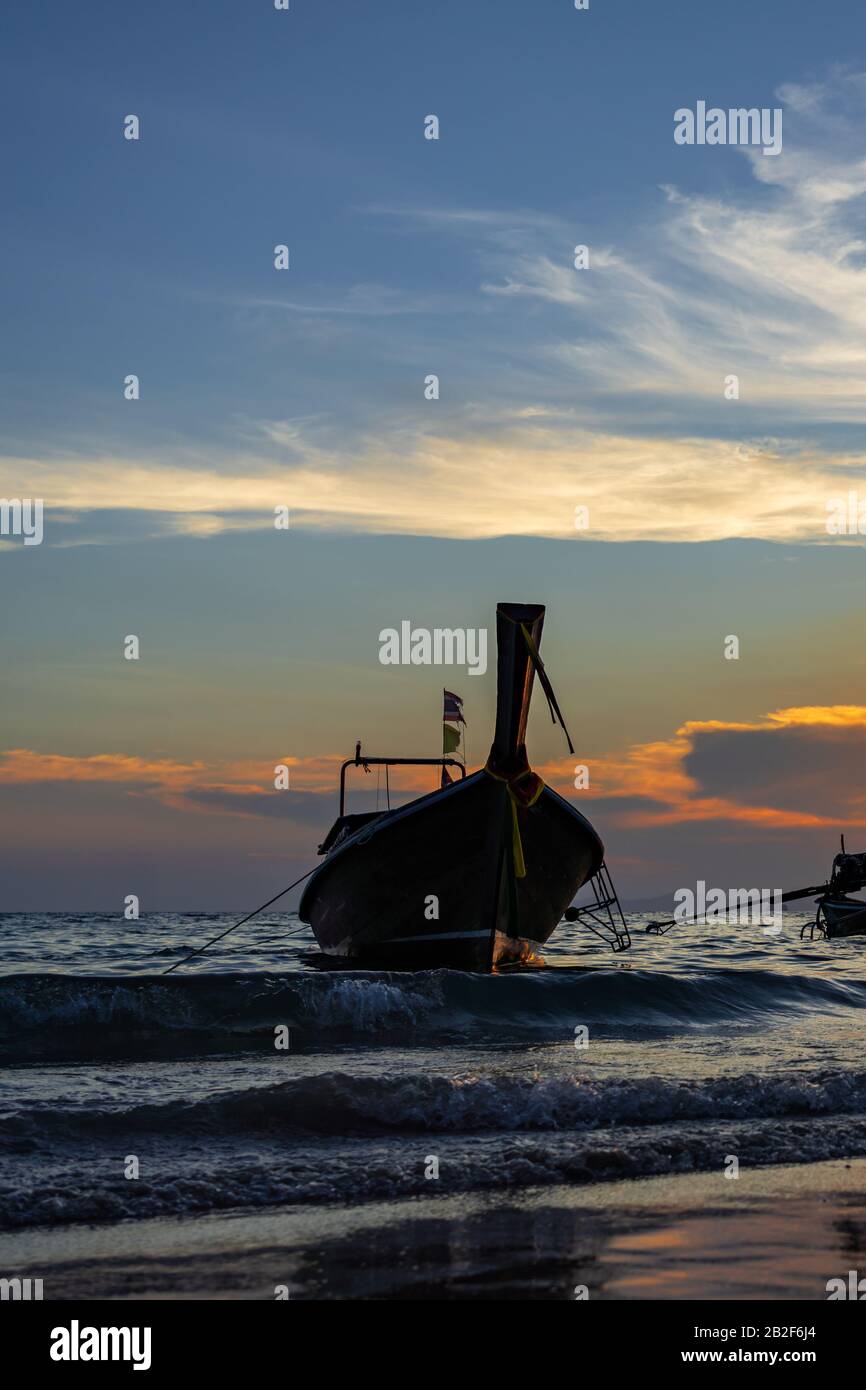 Traditional long-tail boat on the beach in Thailand Stock Photo - Alamy