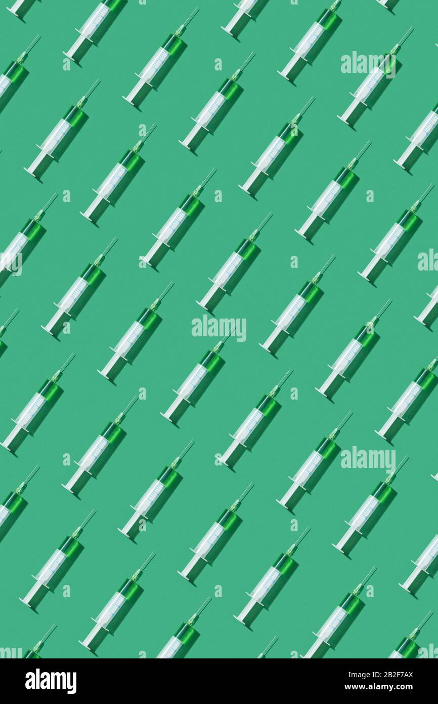 Medicinal pattern from disposable sterile plastic syringes with green ...