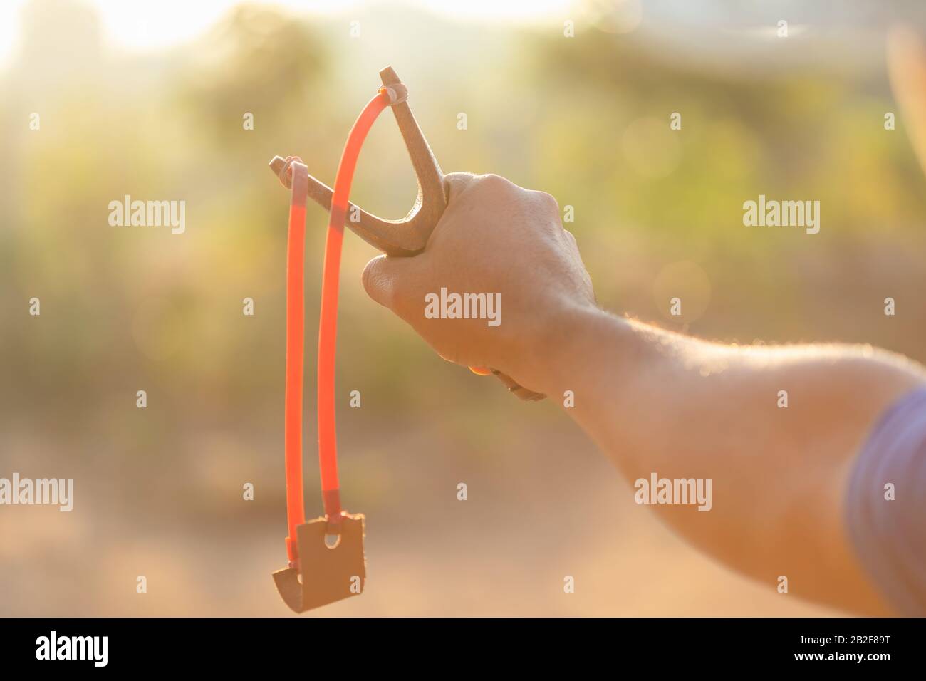 Close up man playing slingshot or catapult in morning time with ...