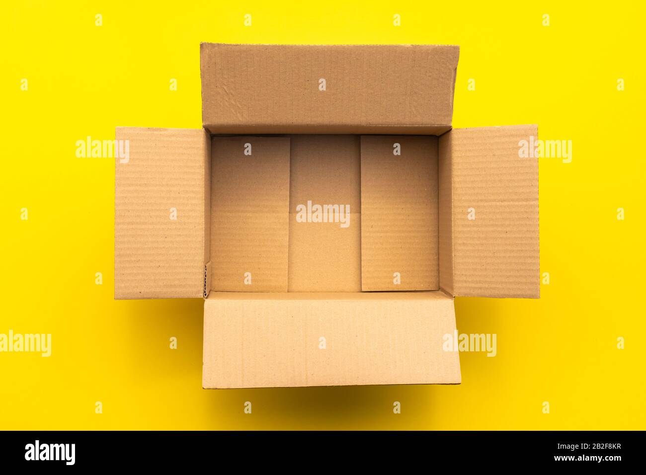 Top view empty brown post or carton box on yellow paper background ...