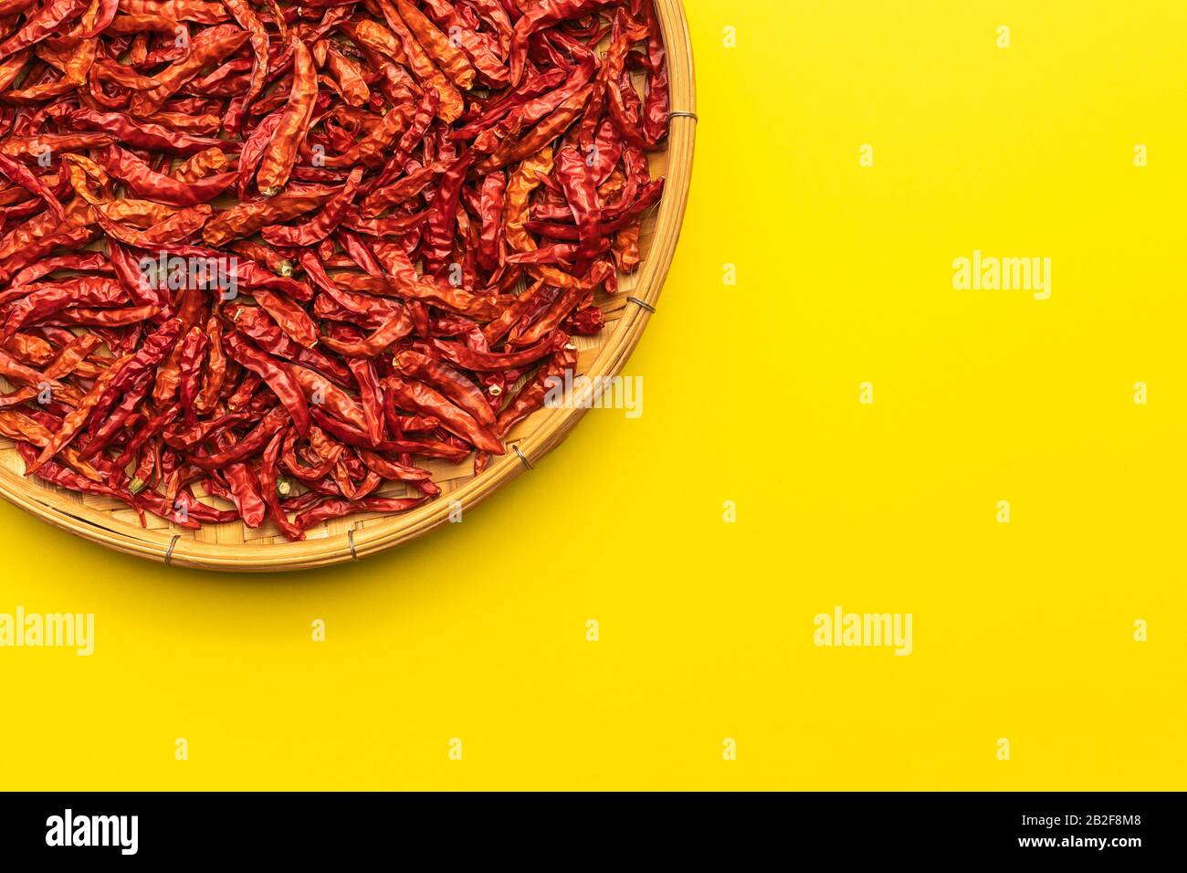 Top view dry red hot Thai chilli yellow paper background. Food concept ...