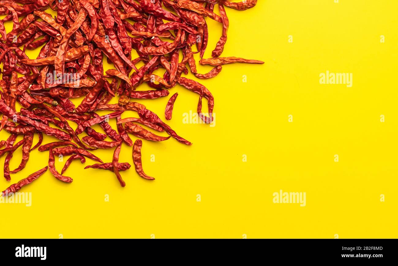 Top view dry red hot Thai chilli yellow paper background. Food concept ...