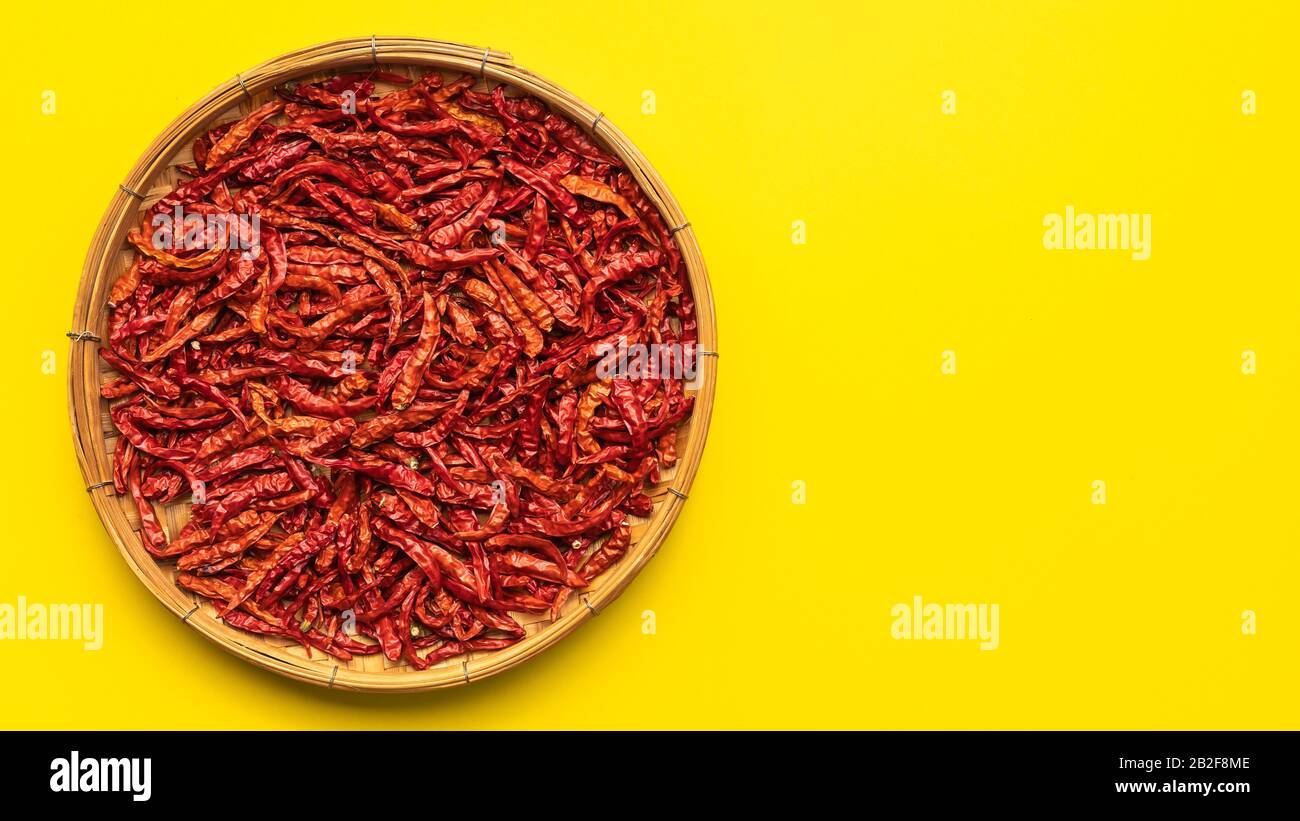 Top view dry red hot Thai chilli yellow paper background. Food concept ...