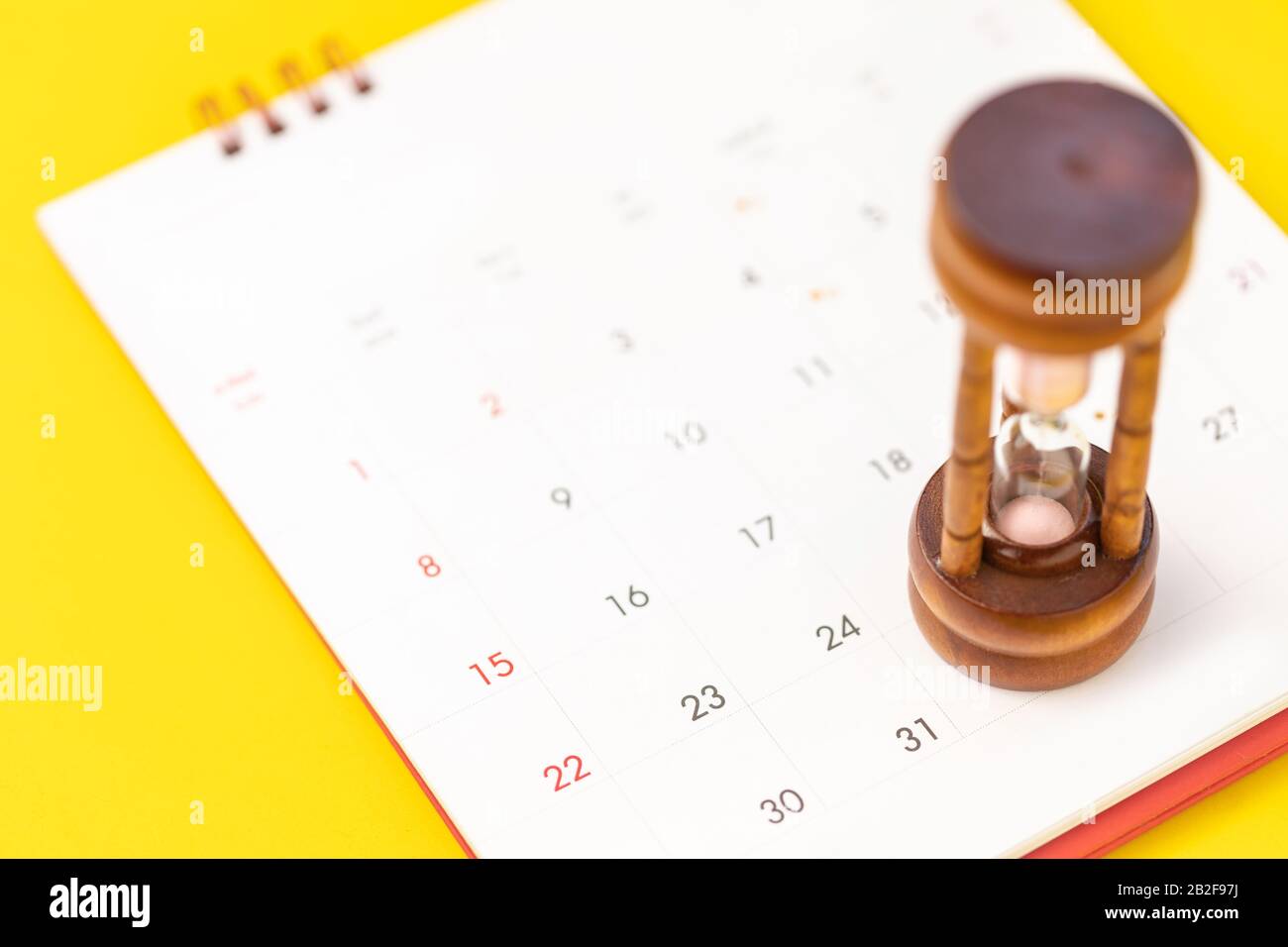 Close up vintage hourglass or sandglass on new year calendar for ...