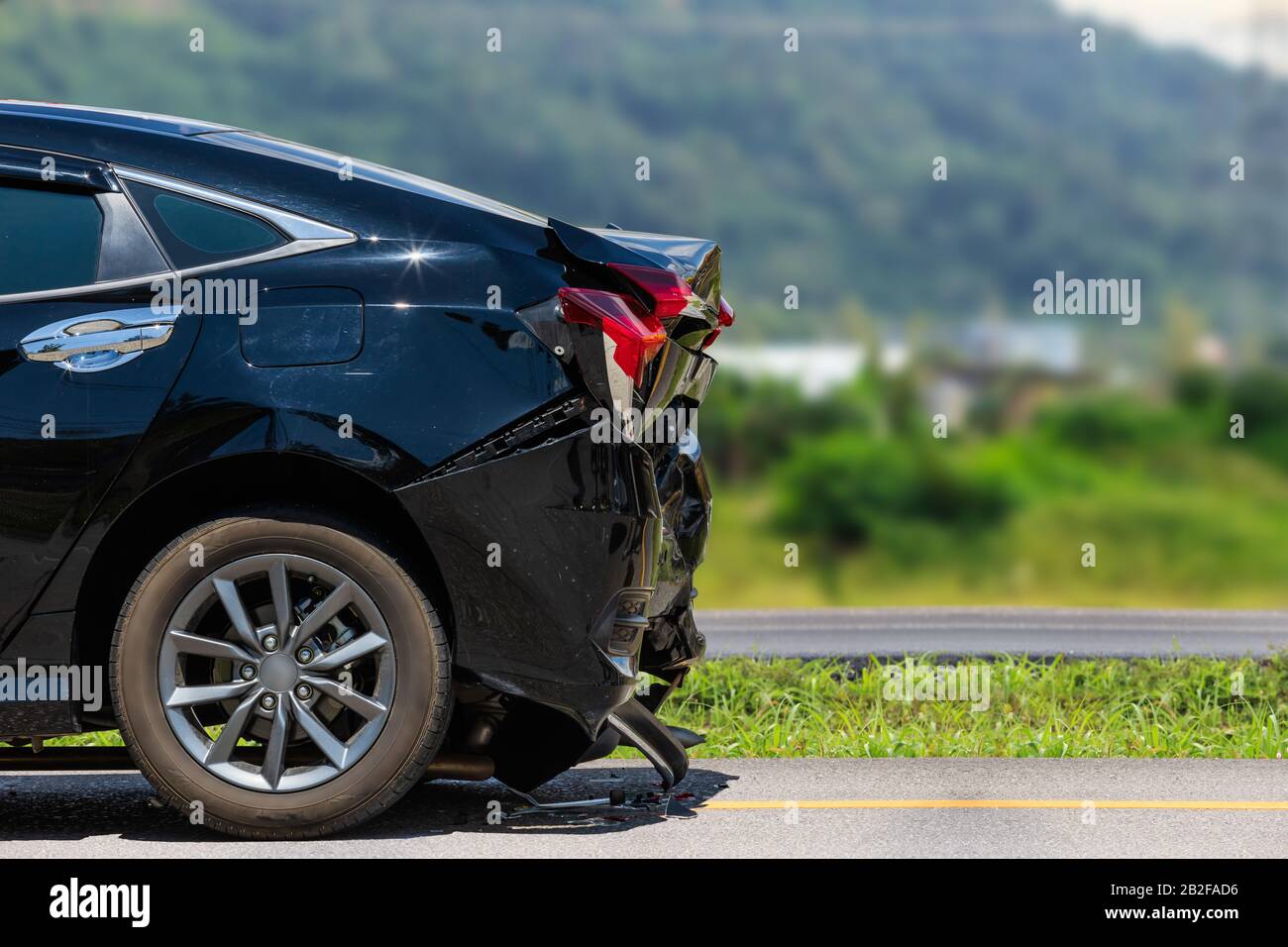 Car accident involving two cars on the road. Back side of black car get ...