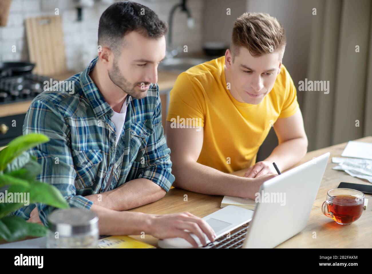Two young men watching hi-res stock photography and images - Alamy