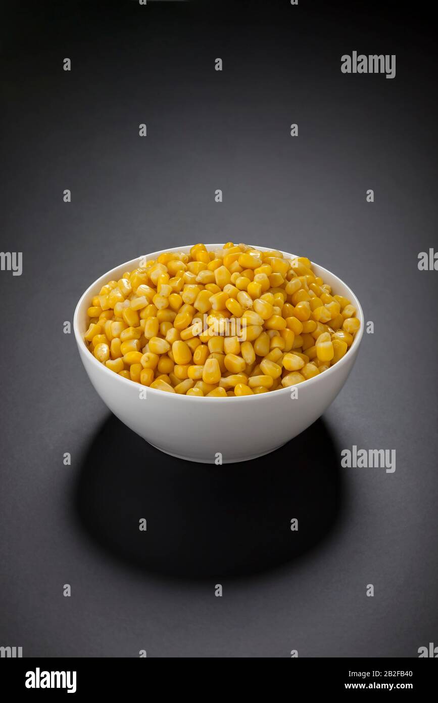 Fresh sweet corn in bowl isolated on black Stock Photo - Alamy