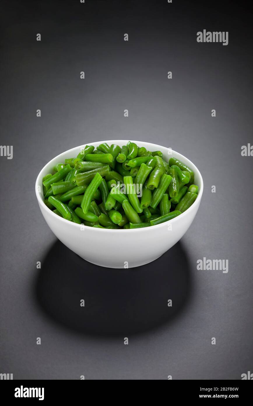 Fresh green beans in bowl isolated on black Stock Photo - Alamy