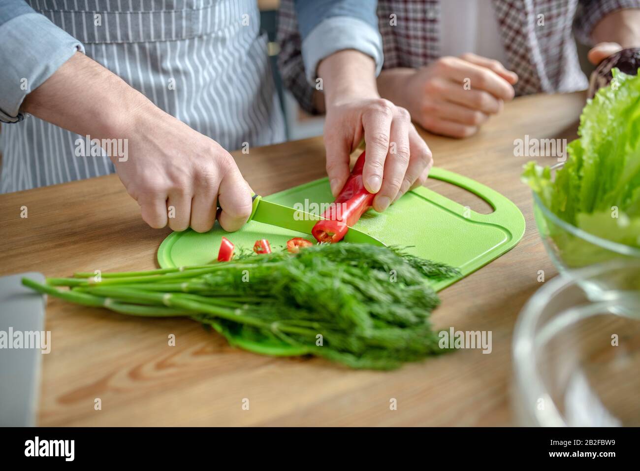 Close up picture of males hands cutting vegetables Stock Photo - Alamy