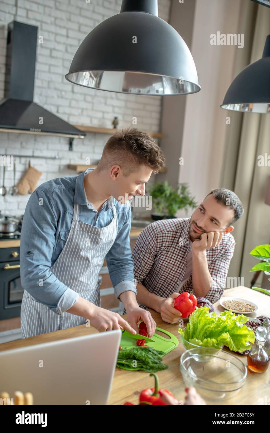 Young gay couple cooking breakfast together feeling happy Stock Photo ...
