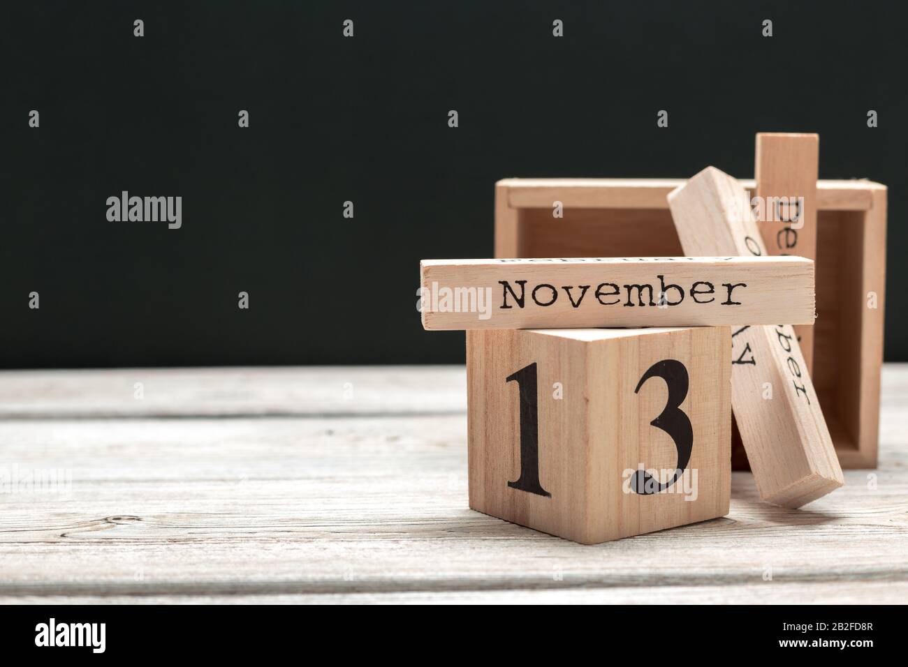 Side view of parts of wooden calendar on dark wooden tabletop Stock ...