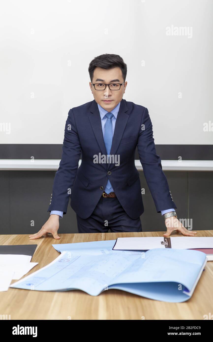 Man standing behind desk Beijing China Stock Photo - Alamy