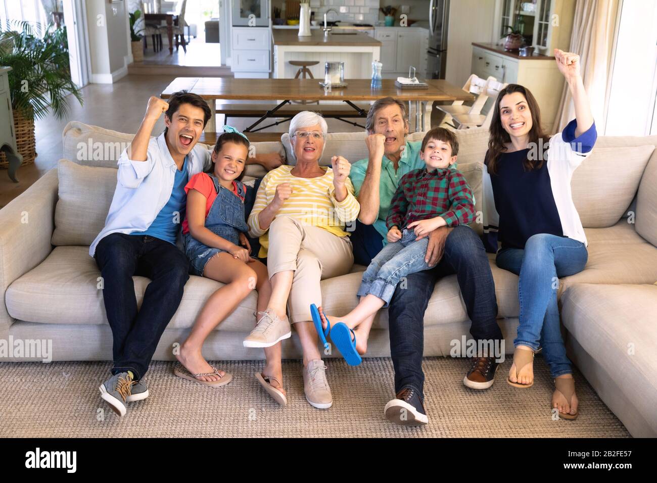 Family members sitting on couch hi-res stock photography and images - Alamy