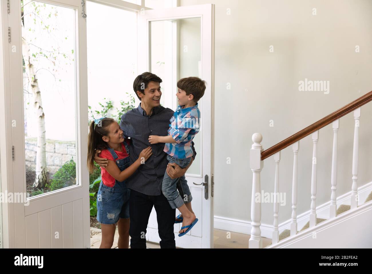 Front view of a Caucasian man with his arm around his daughter and ...