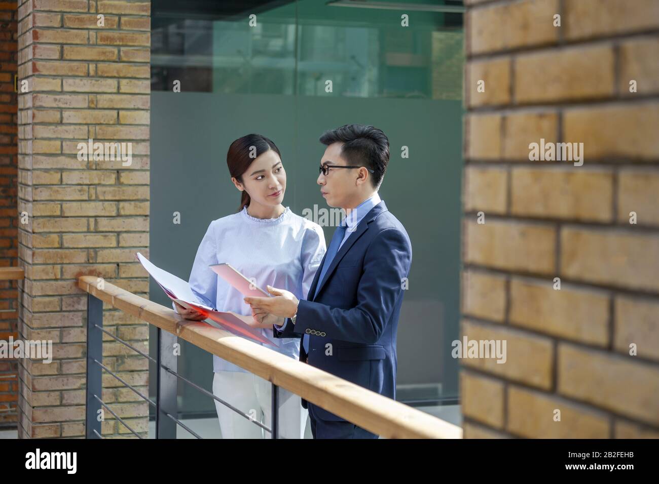 Boss talking to employee Beijing China Stock Photo - Alamy