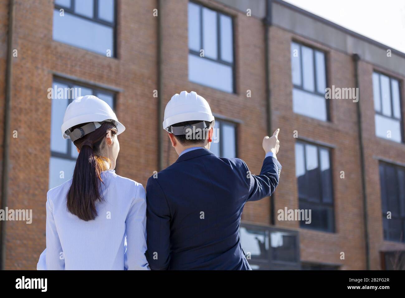Two architects wearing safety helmets Beijing China Stock Photo - Alamy