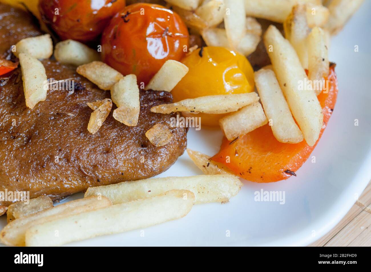 Vegetarian steak made from vegan meat - seitan, with cherry tomatoes ...