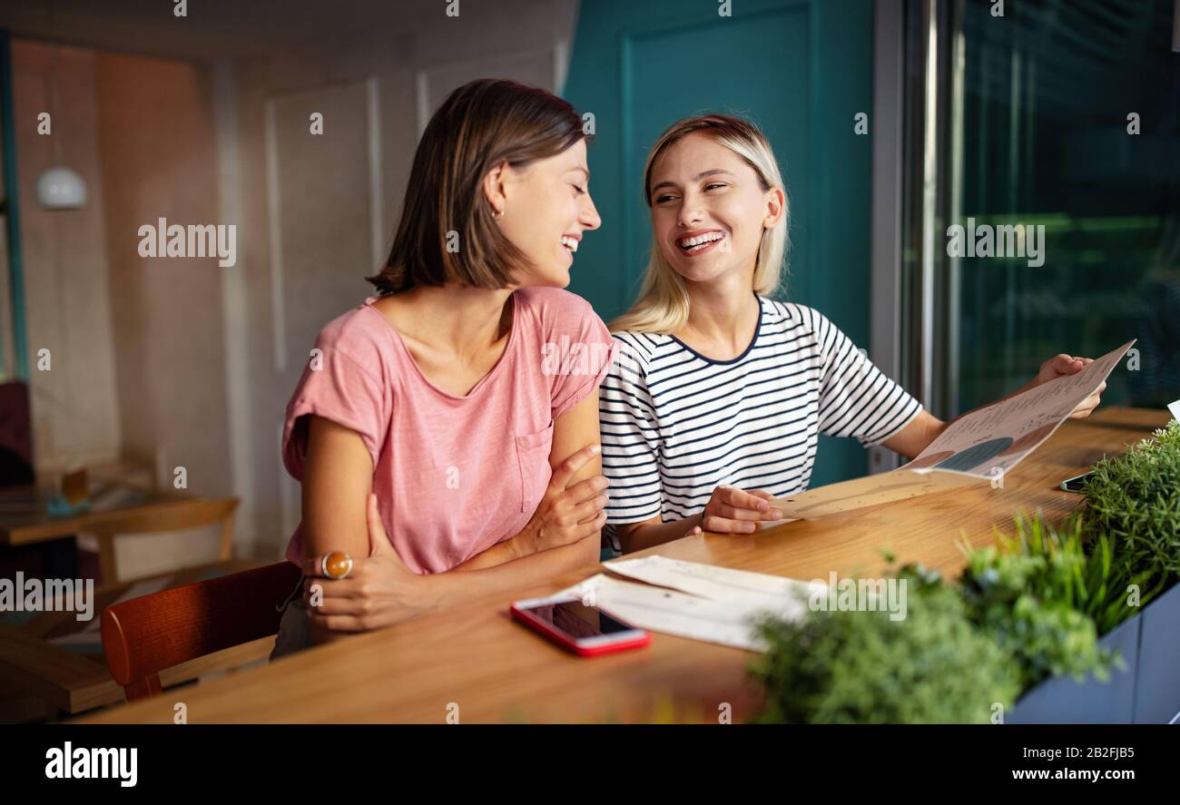 Young female friends talking, smiling and having fun together Stock ...